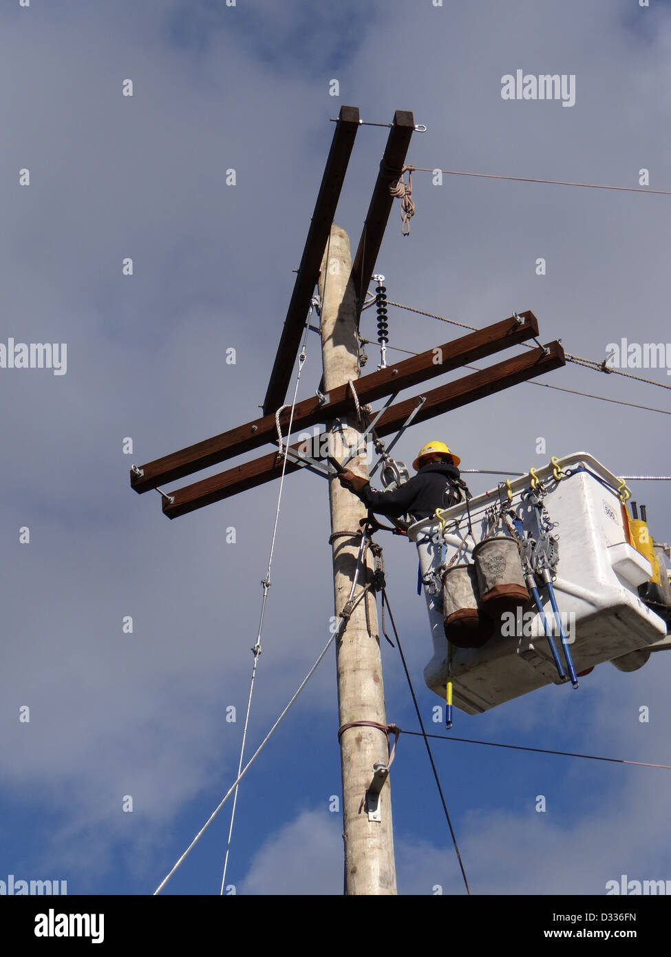 Seattle City Light workmen replace an aging utility pole as part of a ...