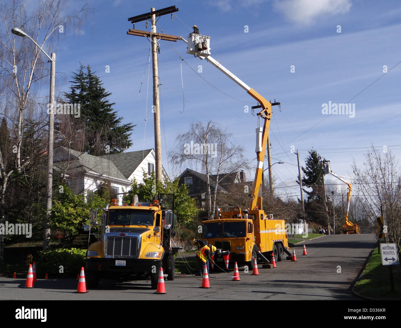 Seattle City Light workmen replace an aging utility pole as part of a ...