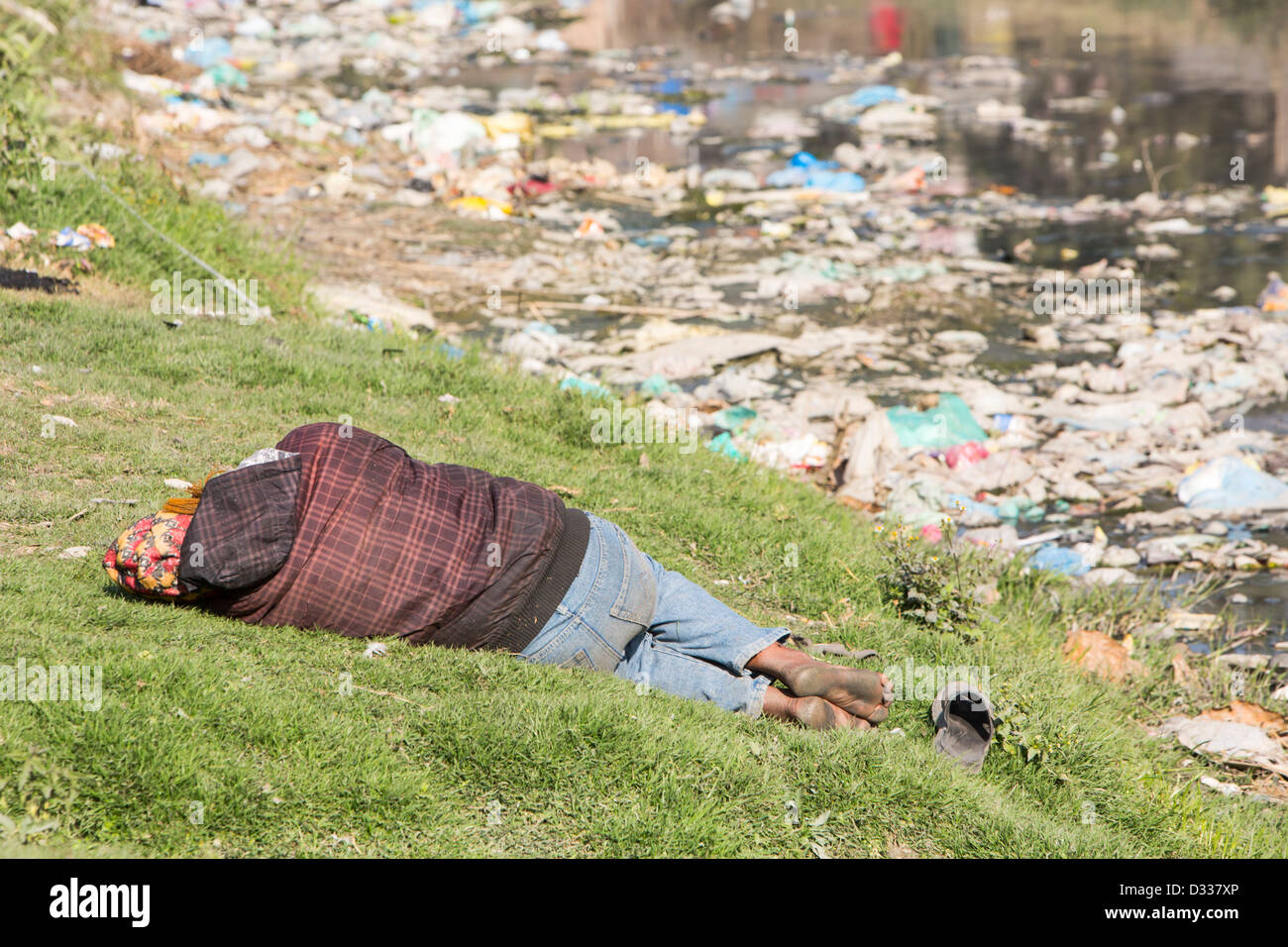 A man sleeping on the banks of the Bishnumati river running through ...