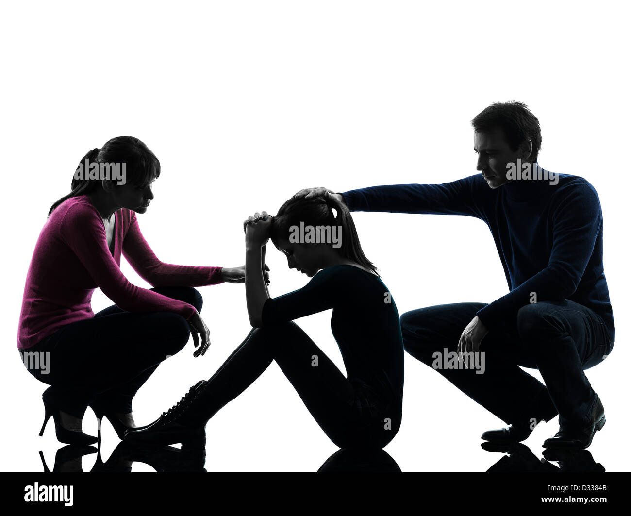 one family father mother consoling daughter in silhouette studio ...