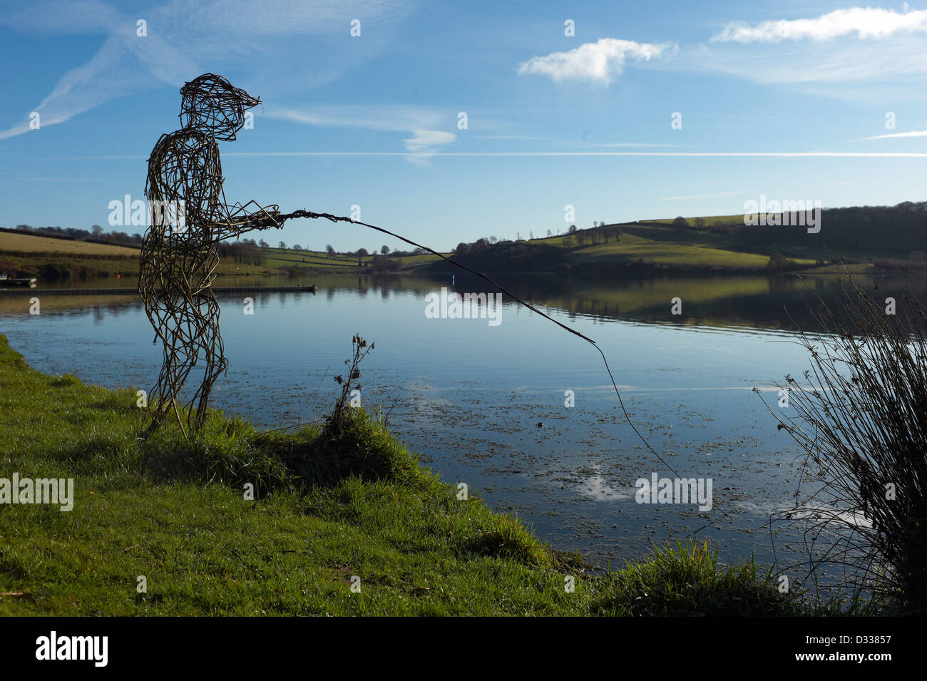 Willow sculpture of man fishing at Wimbleball reservoir Exmoor National ...
