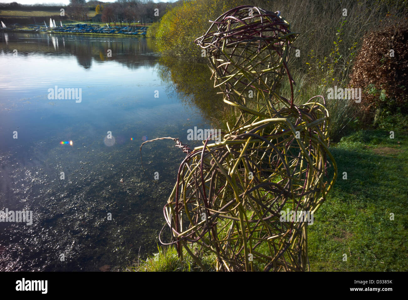 Willow sculpture of man fishing at Wimbleball reservoir Exmoor National ...