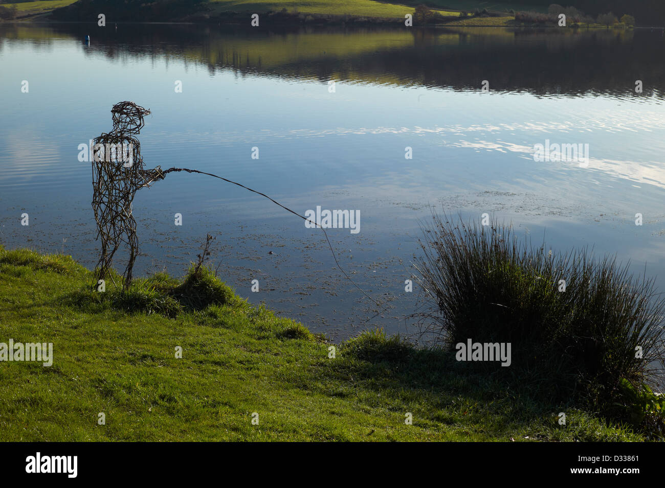 Willow sculpture of man fishing at Wimbleball reservoir Exmoor National ...
