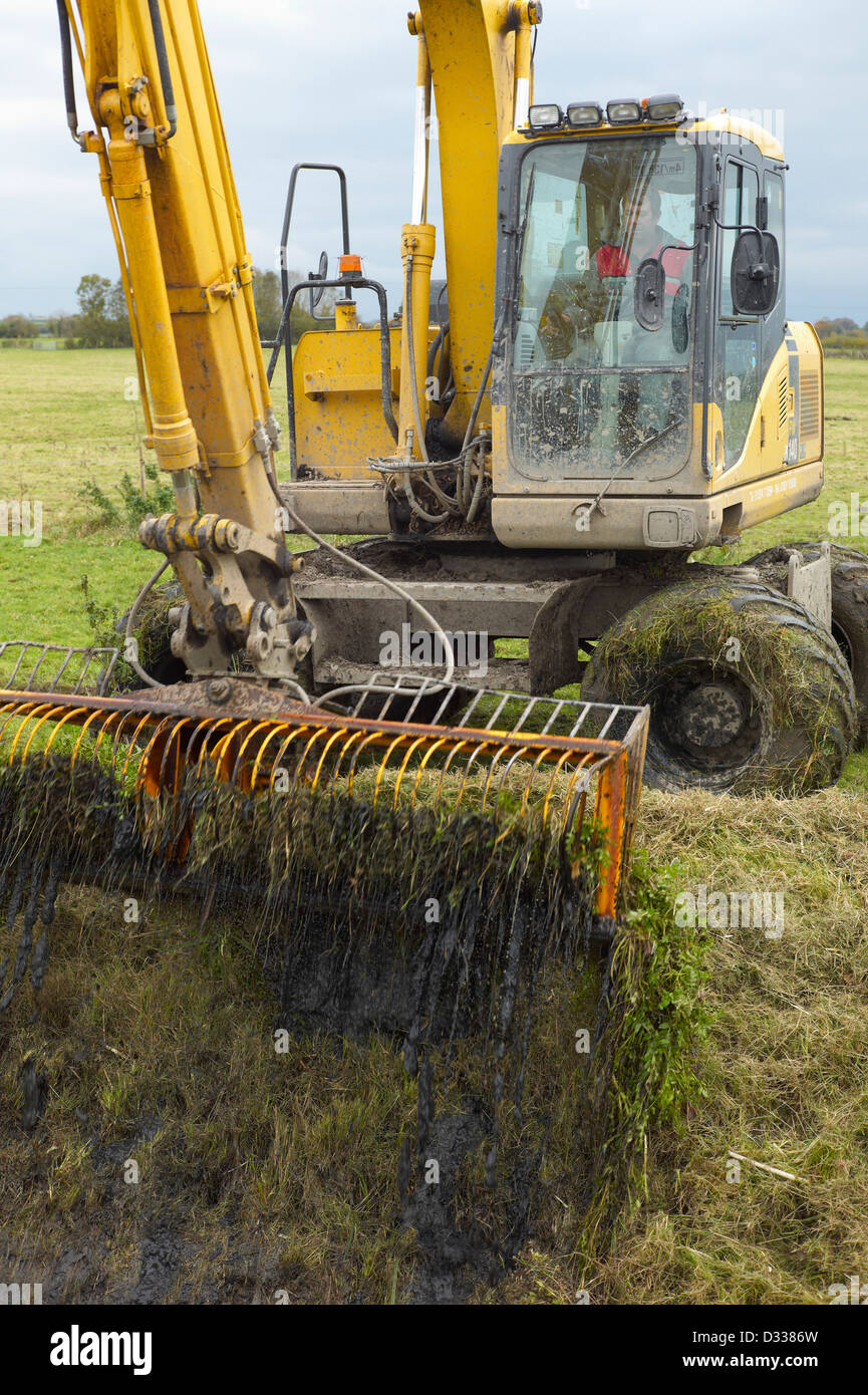 vehicle removing weed from ditch North Somerset England Stock Photo - Alamy