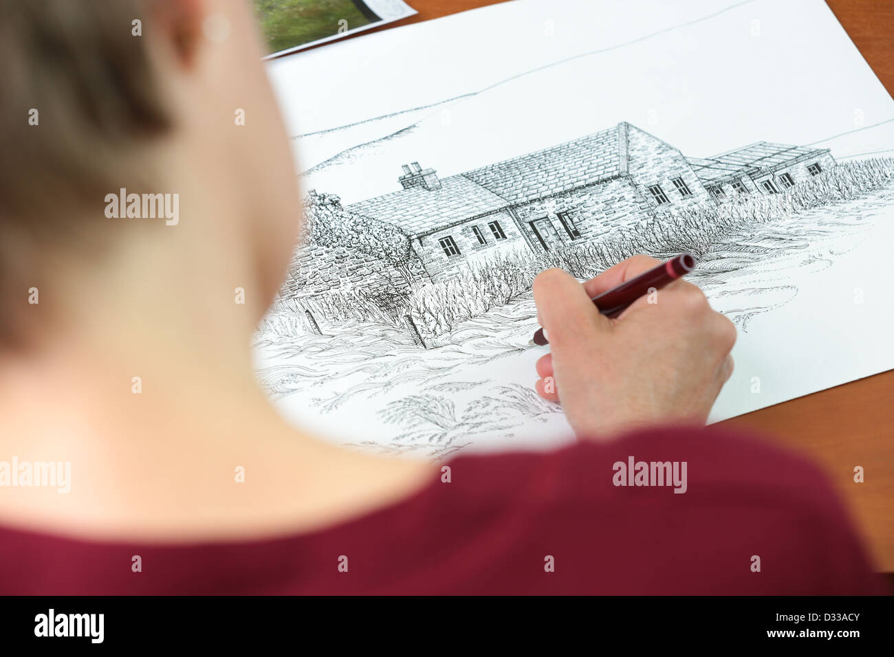 Artist drawing / sketching in studio pen and ink line drawing of old ...