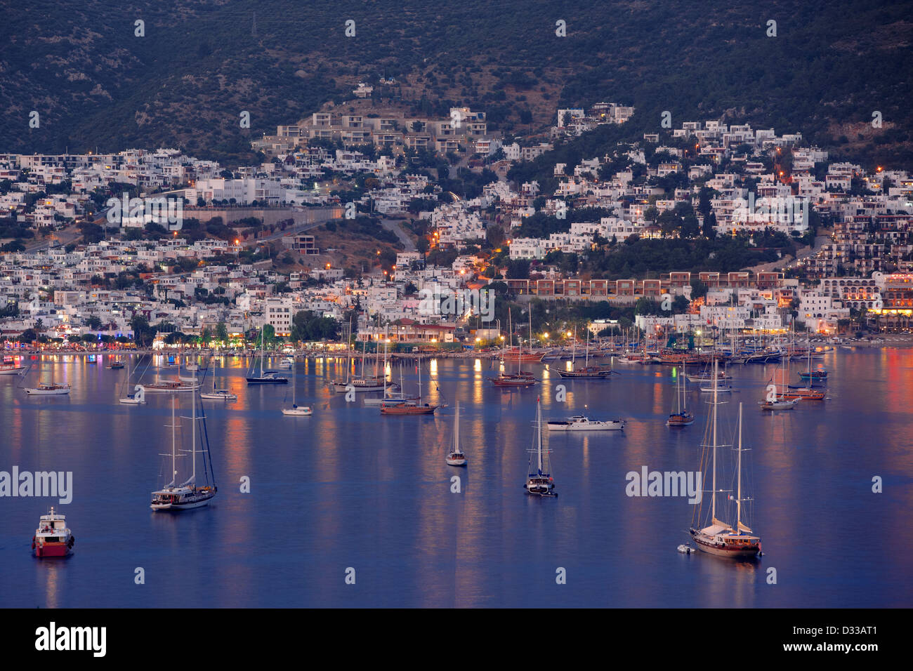 Elevated view of Bodrum harbor and city illuminated at dusk. Bodrum ...