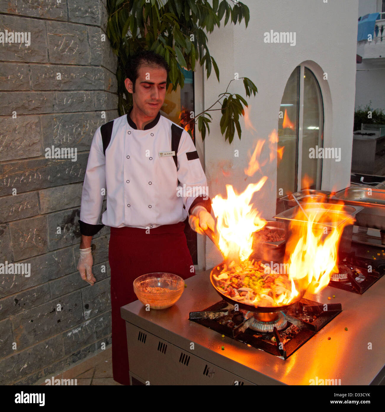 Hot oil on a frying pan bursts into flames while a restaurant's chef ...