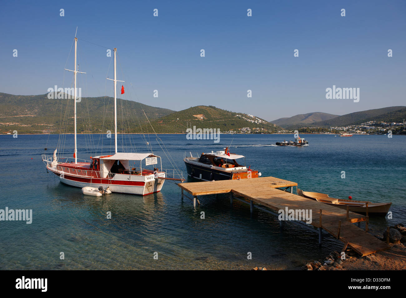 Pier with moored boats at Torba bay. Bodrum Peninsula, Turkey Stock ...