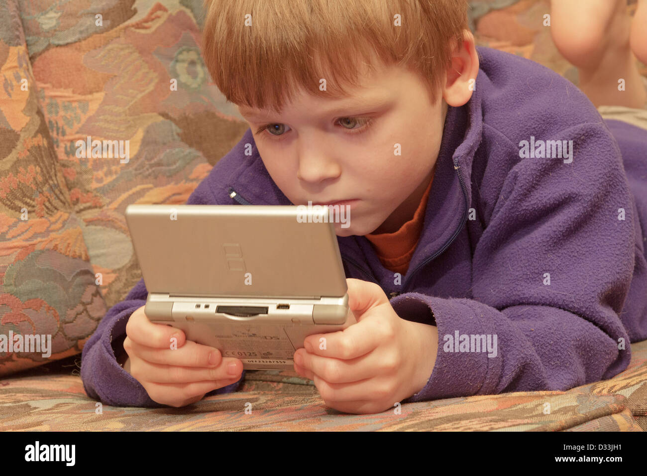 portrait of a young boy playing with his Nintendo Stock Photo - Alamy