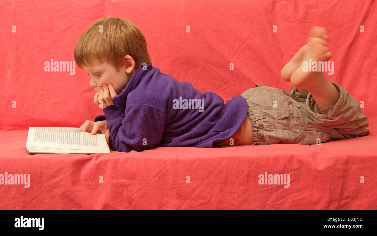 portrait of a young boy reading a book Stock Photo - Alamy