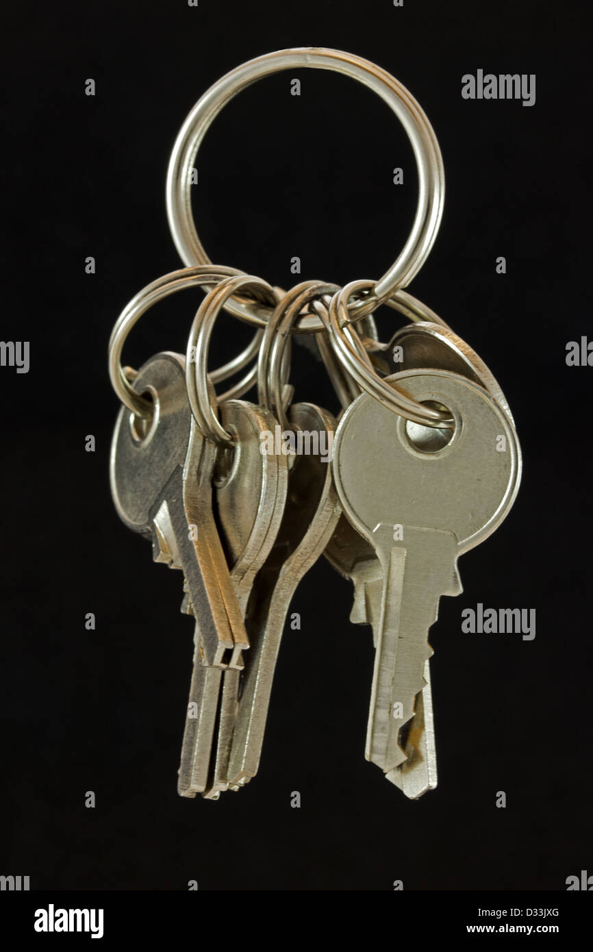 Set of steel small keys on keyring against black background Stock Photo ...