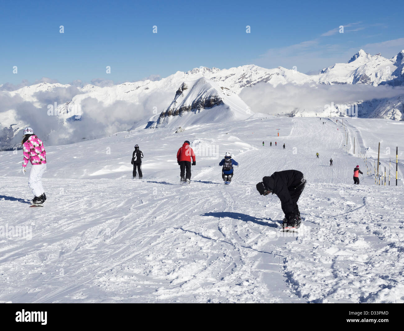 Snowboarders snowboarding blue snow slope Serpentine piste on Les ...