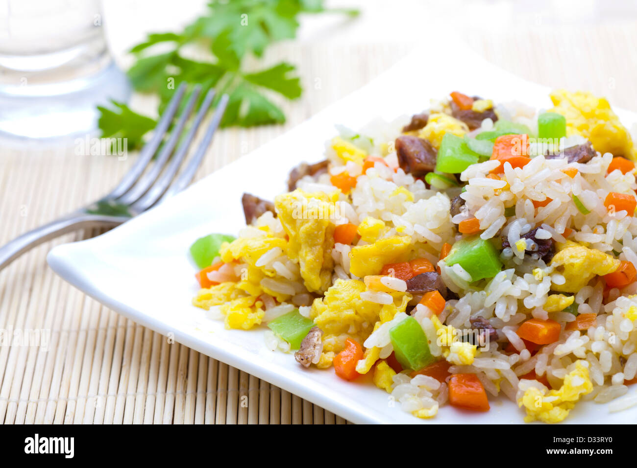 A plate vegetable fried rice placed on bamboo mat Stock Photo - Alamy