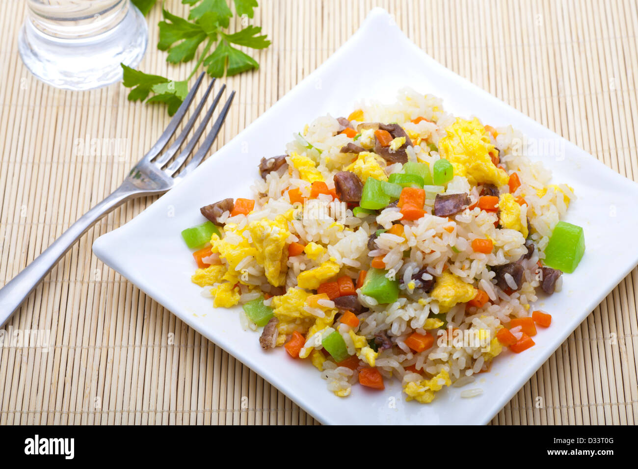 A plate vegetable fried rice placed on bamboo mat Stock Photo - Alamy