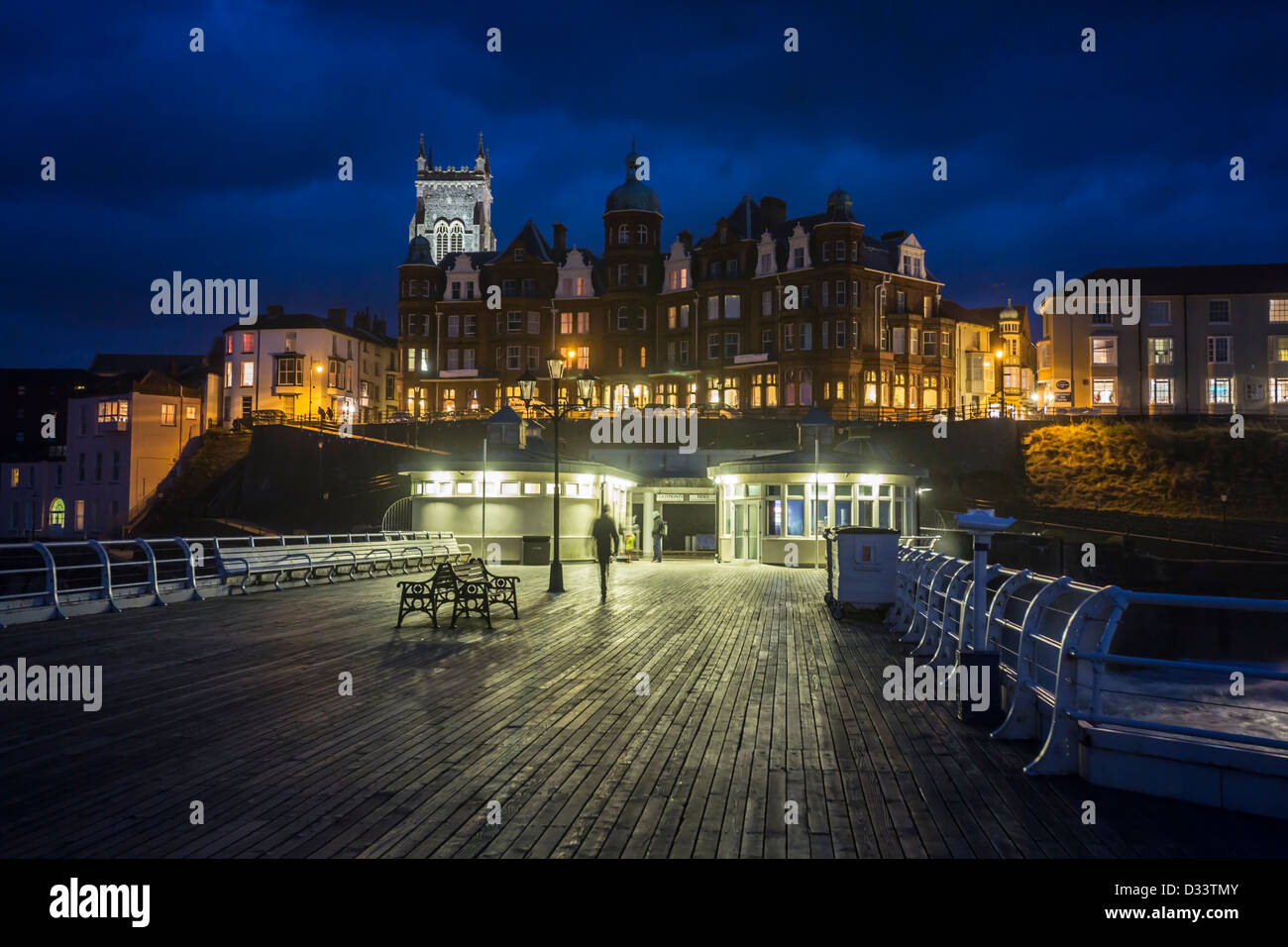 person walking on Cromer Pier at night with lights illuminating Hotel ...