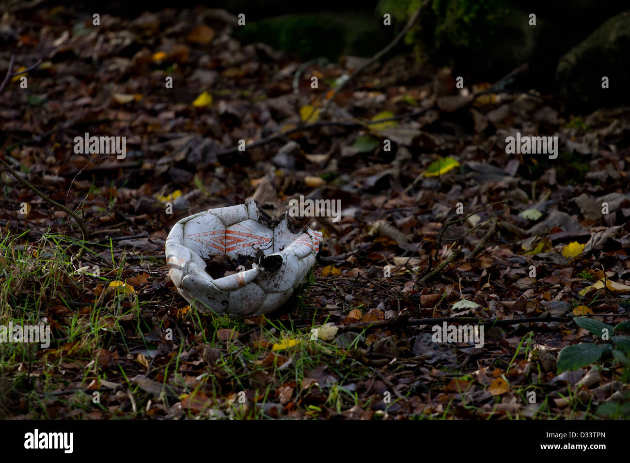 Old Popped football in dead leaves Stock Photo - Alamy