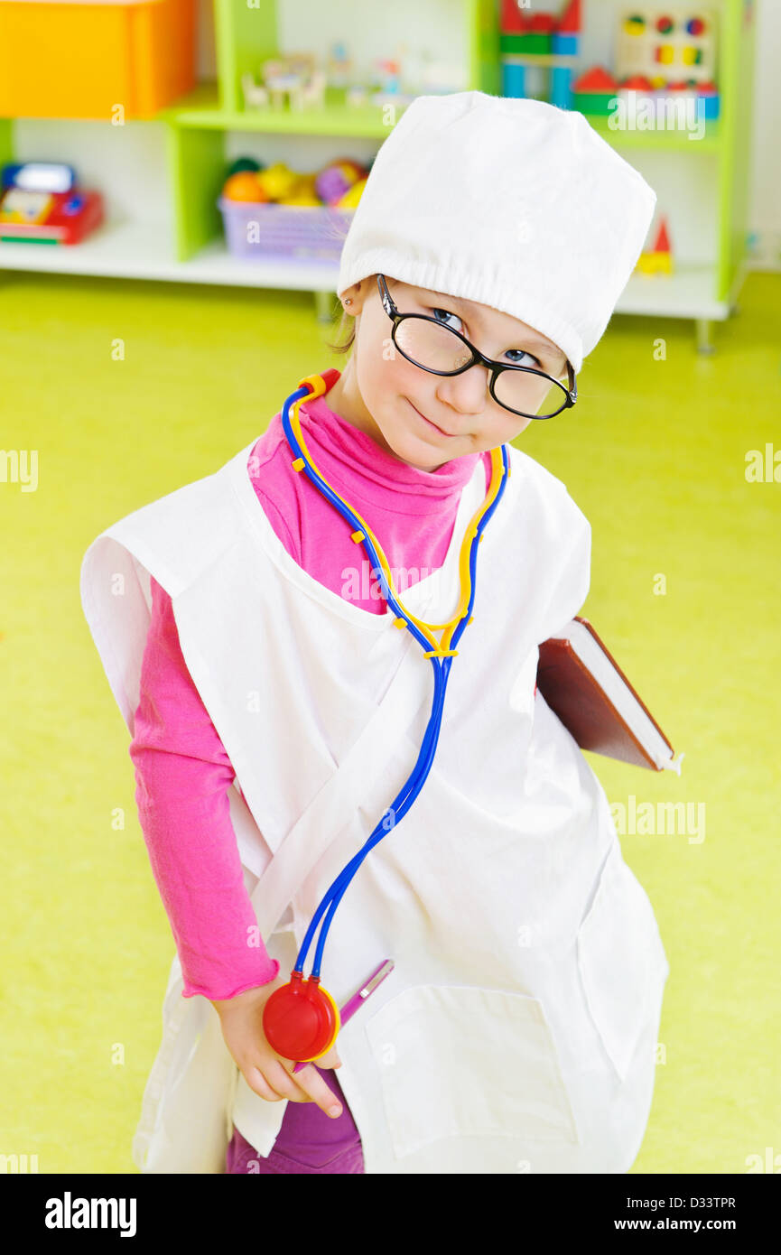 Cute little girl in medical uniform playing in doctor Stock Photo - Alamy