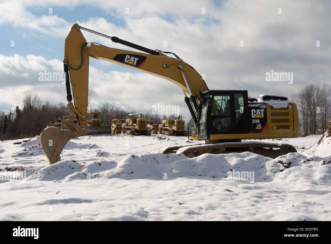 Cat excavator parked on construction site Stock Photo - Alamy