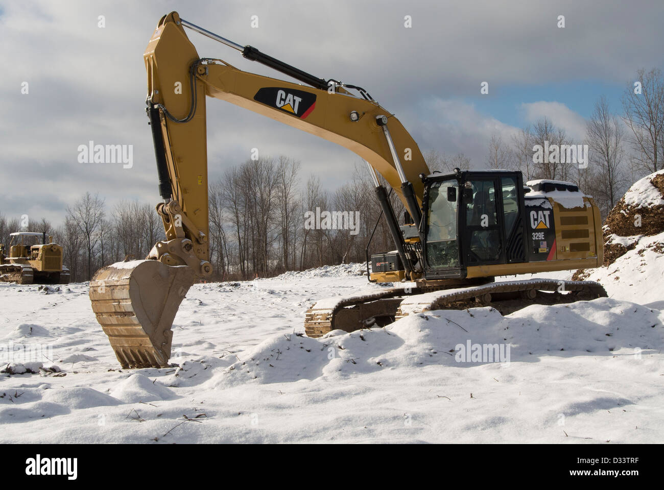 Cat excavator parked on construction site Stock Photo - Alamy