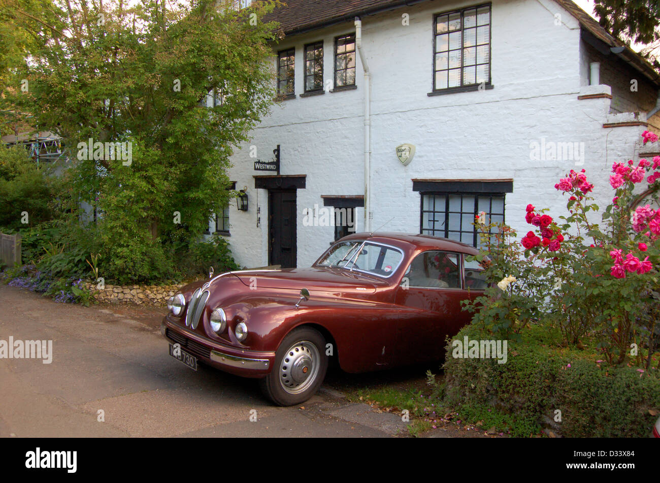 Classic car parked outside a white cottage. Editorial only 19 June 2011 ...