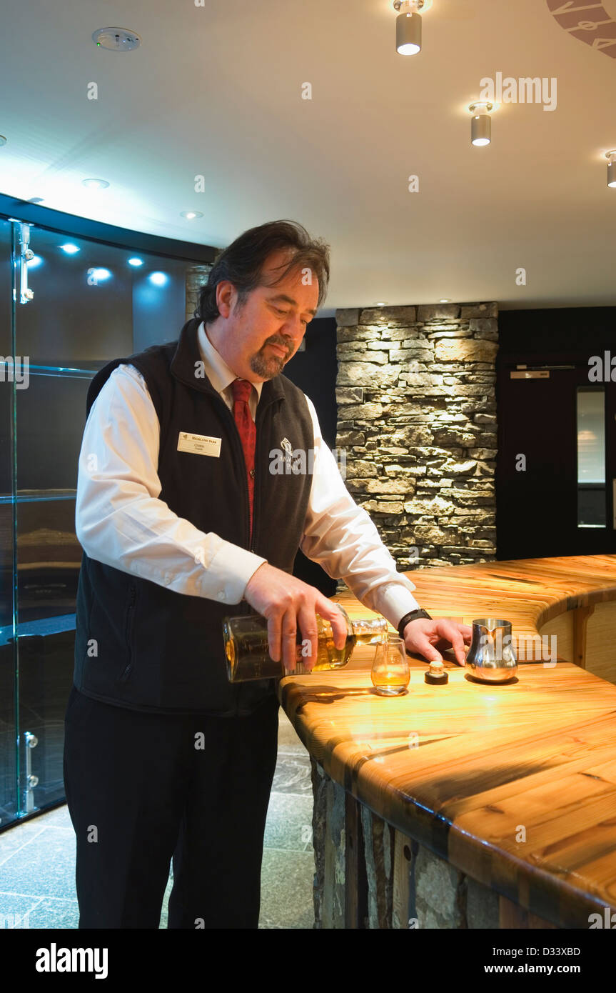 A tour guide pouring a complimentary dram in the Tasting Room of the ...