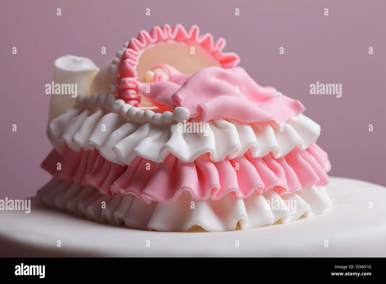 Birthday cake with mastic and little baby in bed Stock Photo - Alamy