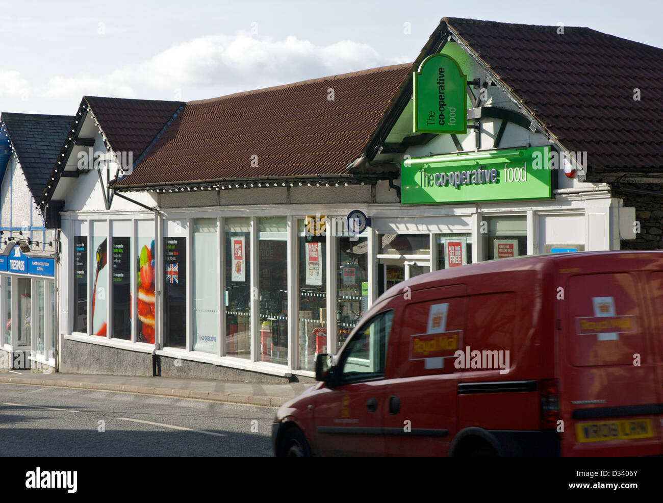 Royal Mail van passing Co-operative store in Bowness, Lake District ...