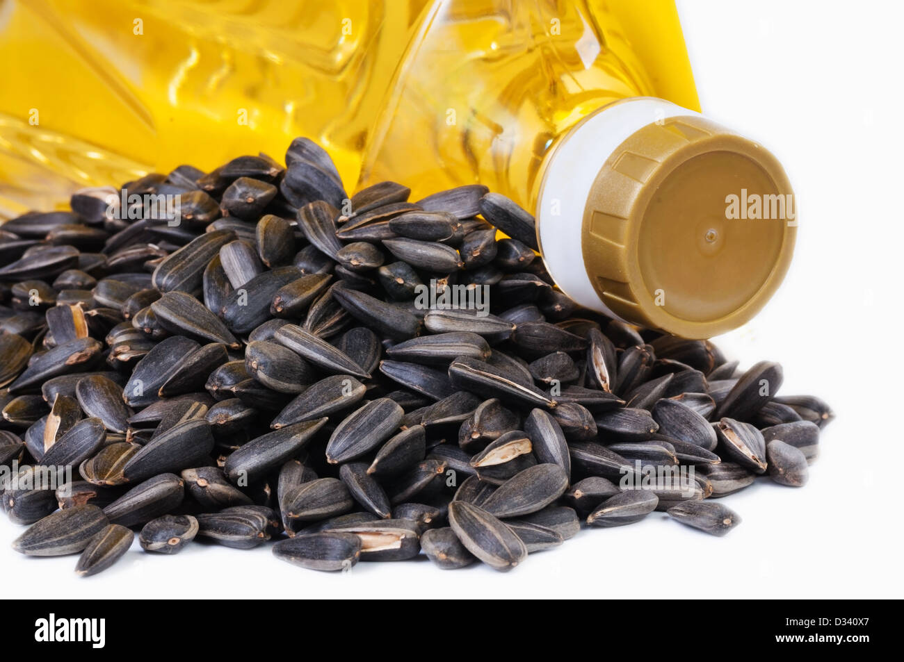Seeds and sunflower oil in bottle on white Stock Photo - Alamy