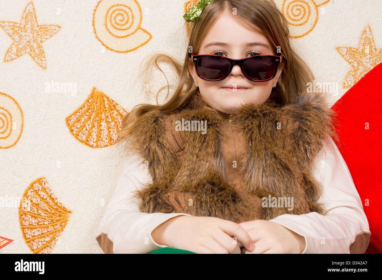 Pretty young girl with an amused expression posing in a pair of large ...