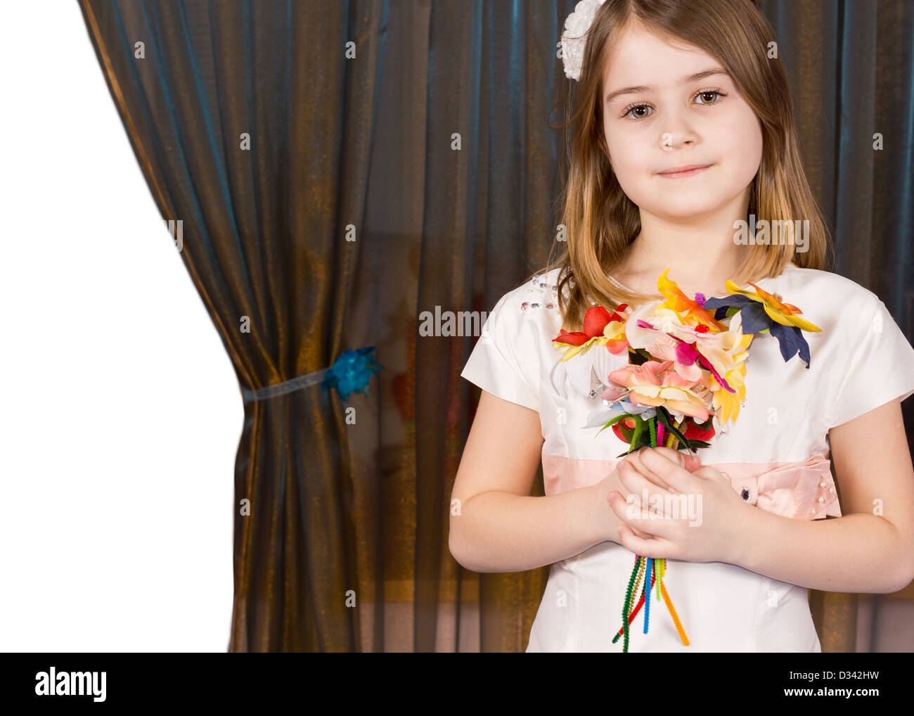 Beautiful little girl posing with a handful of colourful artificial ...