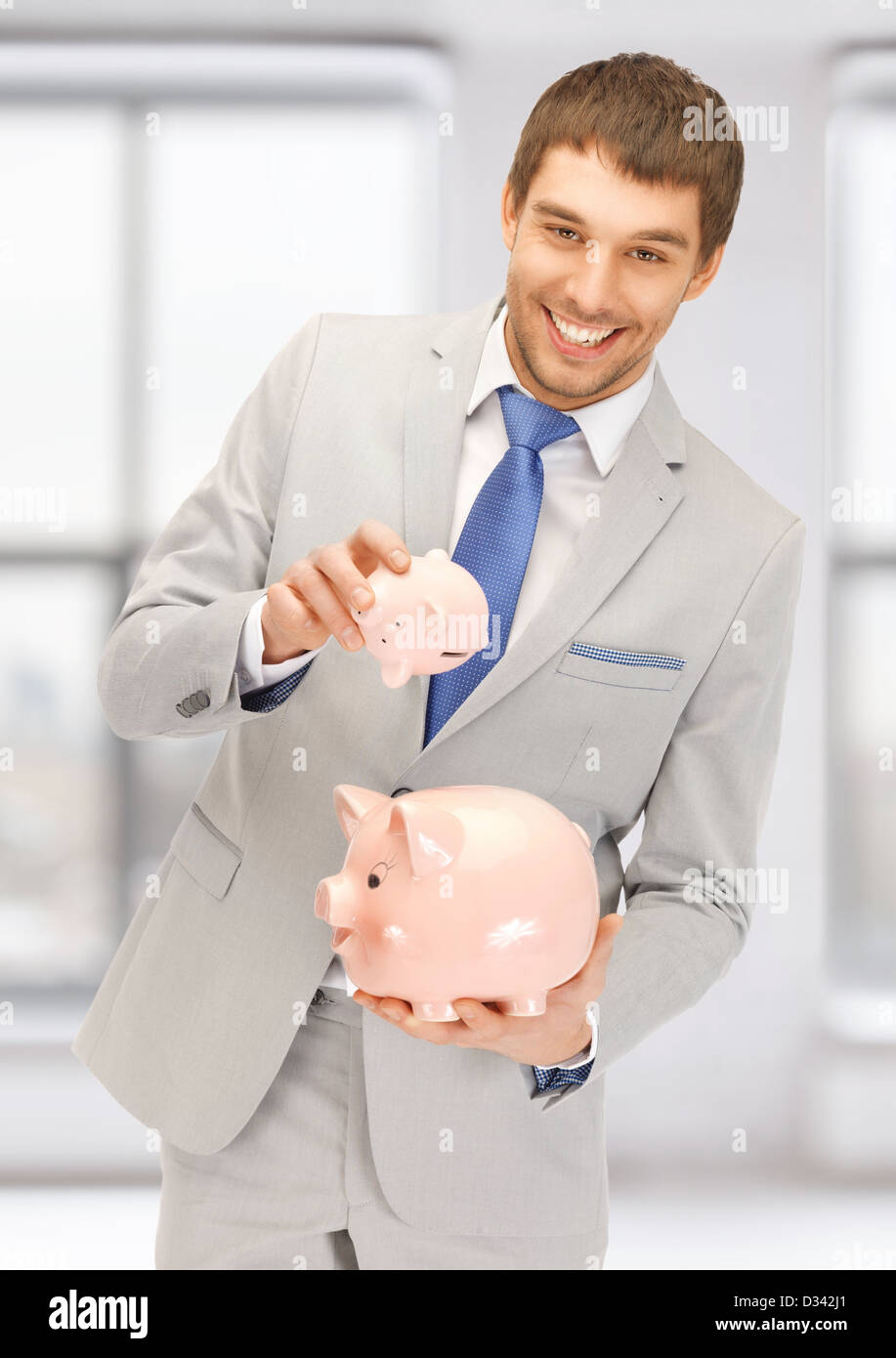 man with two piggy banks Stock Photo - Alamy