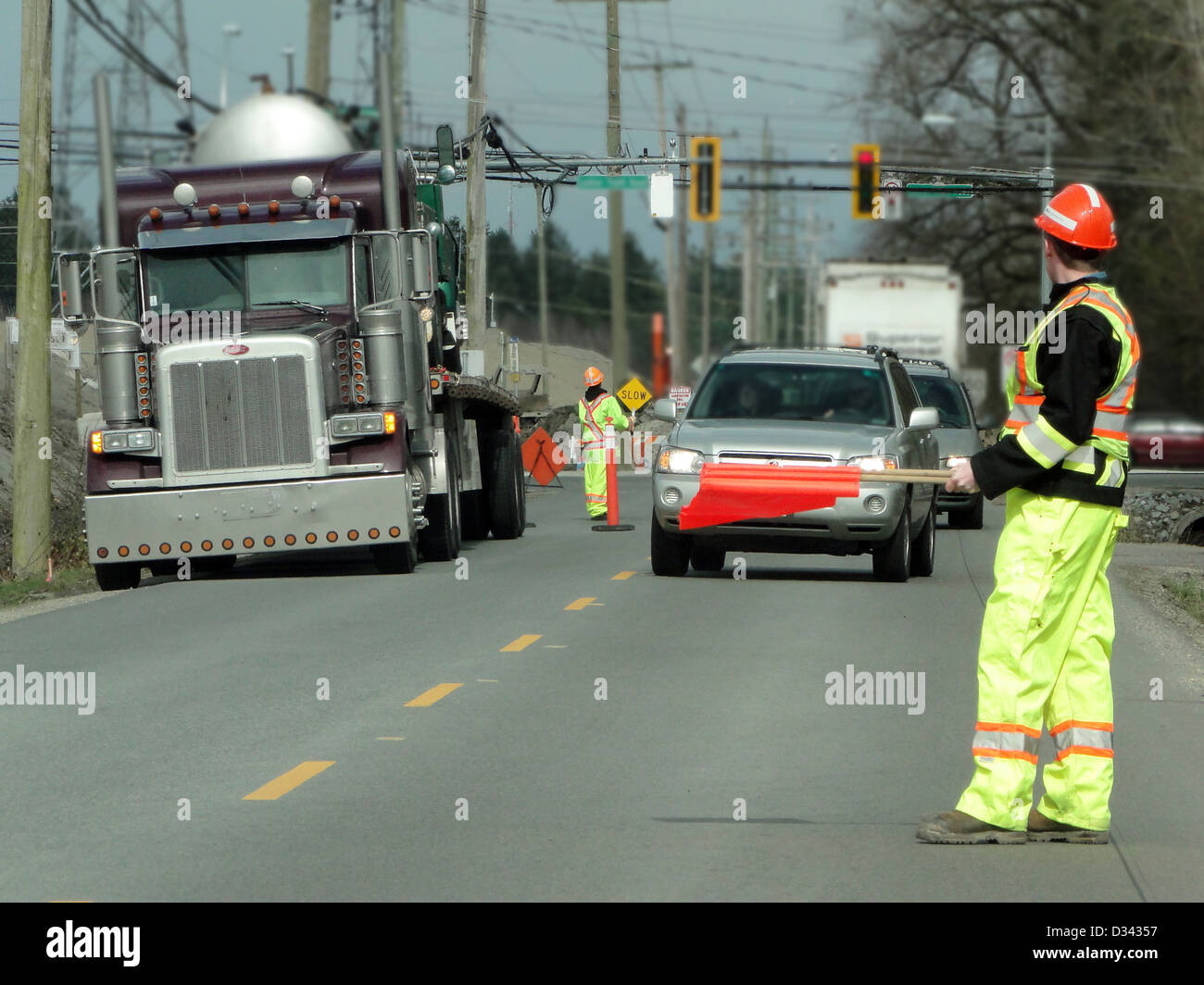VANCOUVER, BC - MAR 19 -Brightly colored workers control traffic in a ...