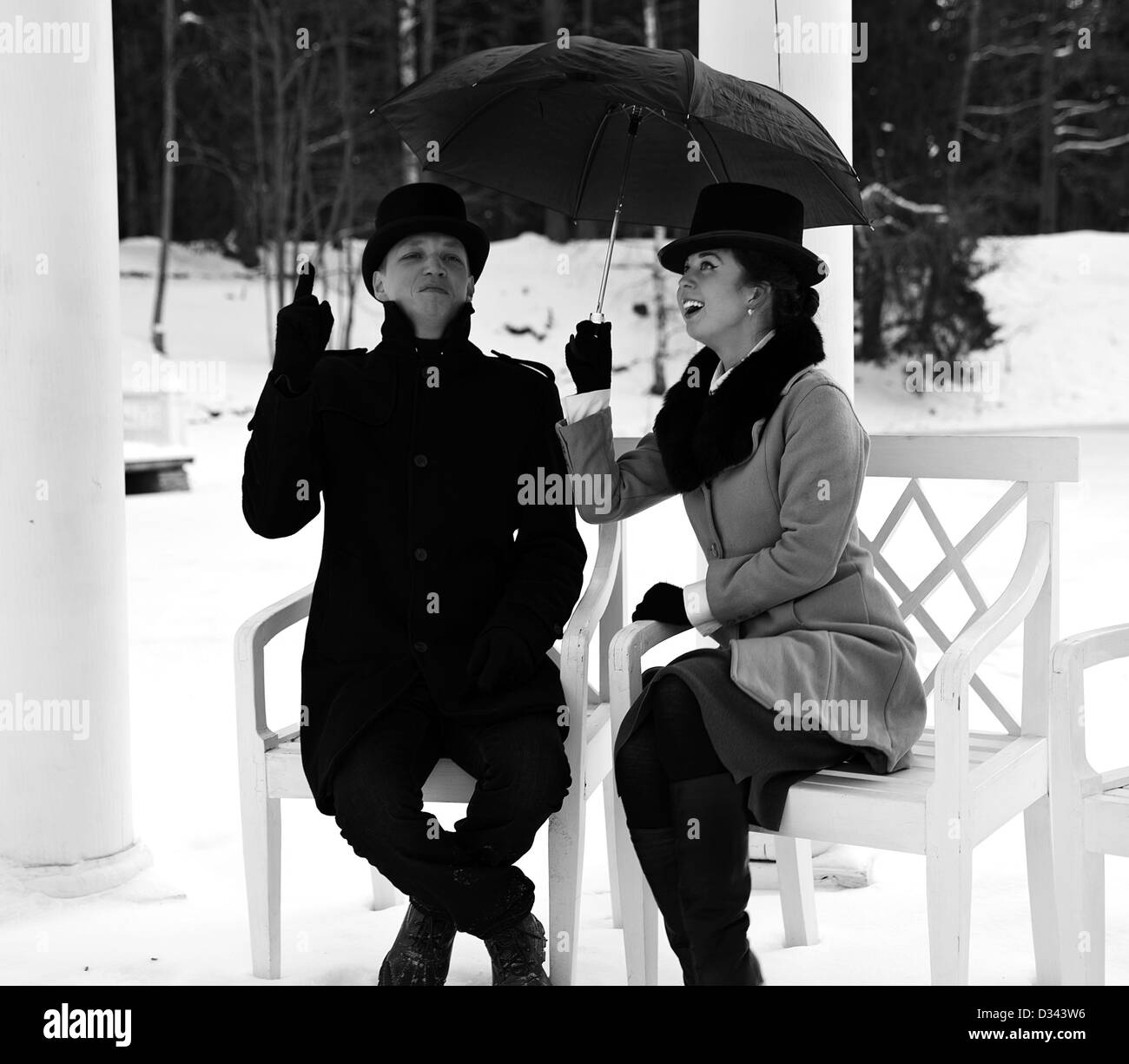Shaded man and woman waiting rain under umbrella Stock Photo - Alamy