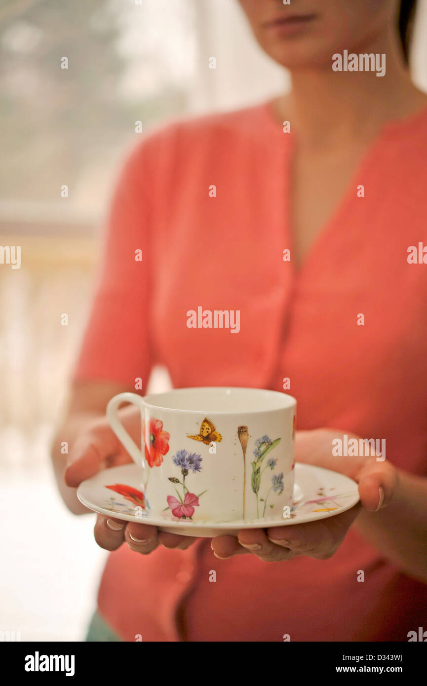 Girl holding a tea cup in her hands Stock Photo - Alamy