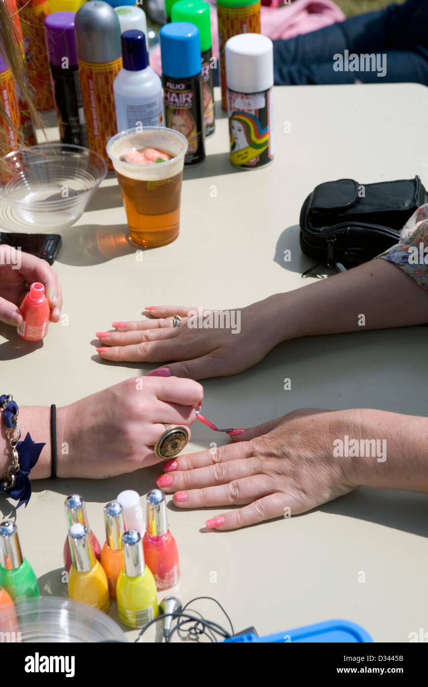 A lady having her nails painted at a summer fair in England Stock Photo ...