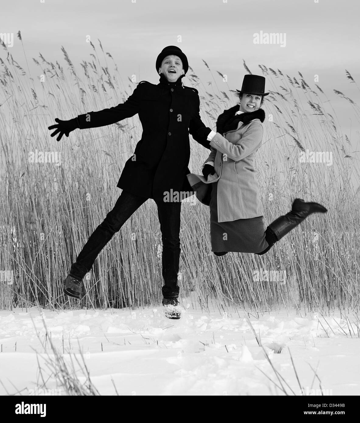 Shaded man and woman jump on frozen lake Stock Photo - Alamy