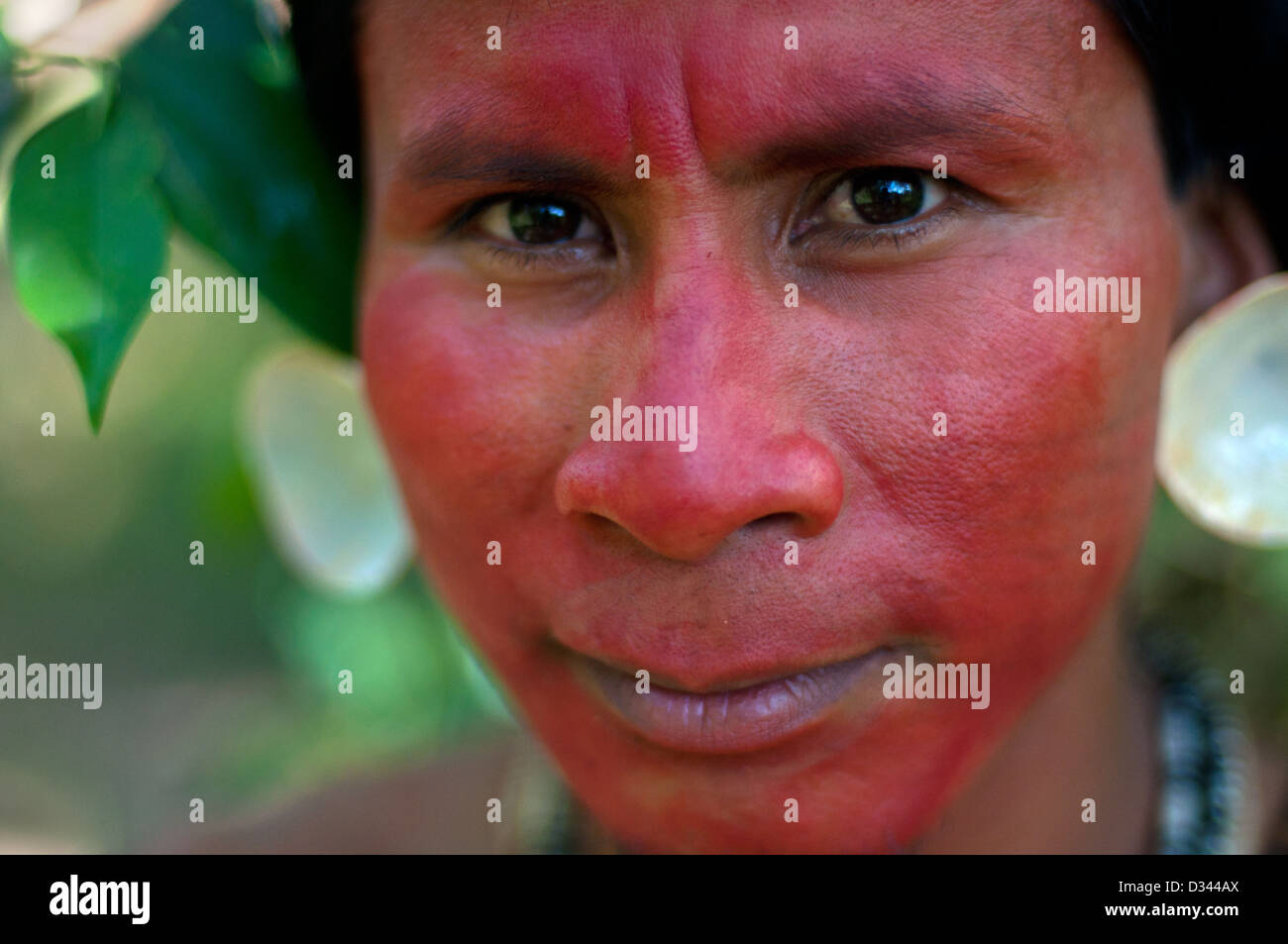 A young Matis man with facial tattoos, shells at his ears, red paint ...