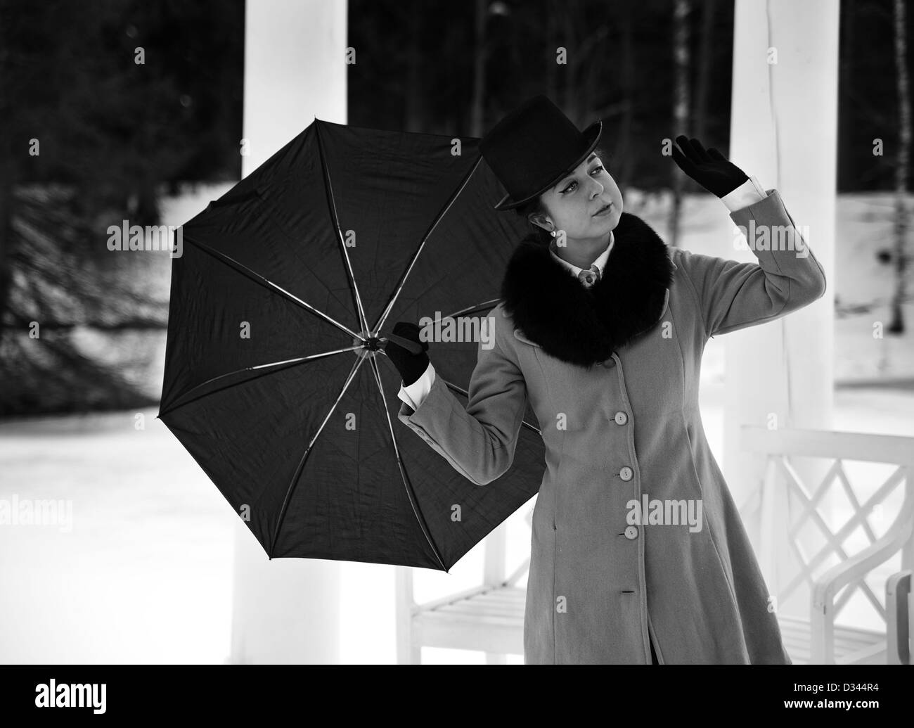 Shaded woman with umbrella feeling winter wind flow Stock Photo - Alamy