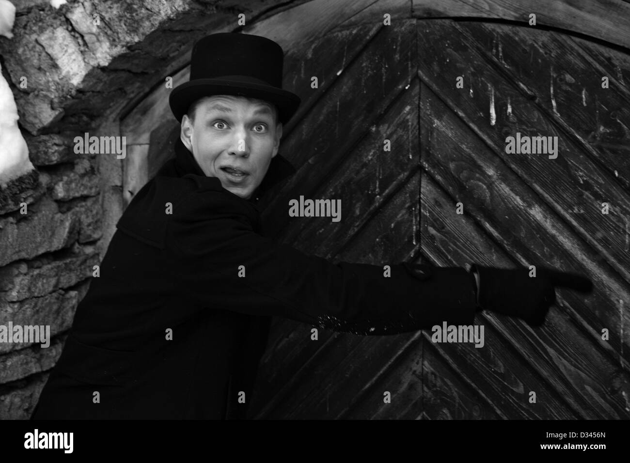 Shaded man pointing with surprise on door lock Stock Photo - Alamy