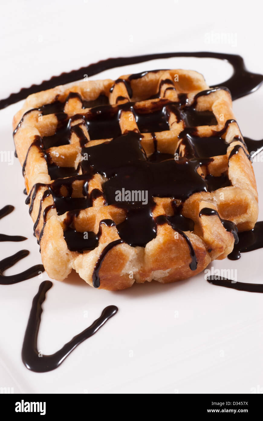 Freshly baked Belgian waffle with chocolate syrup Stock Photo - Alamy