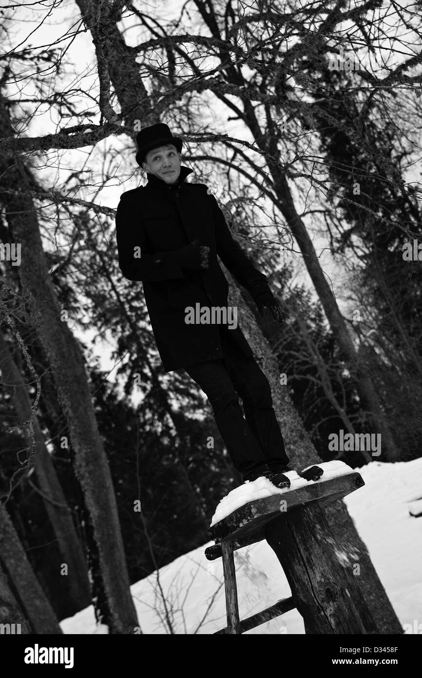 Shaded man standing on wooden stage before jump Stock Photo - Alamy