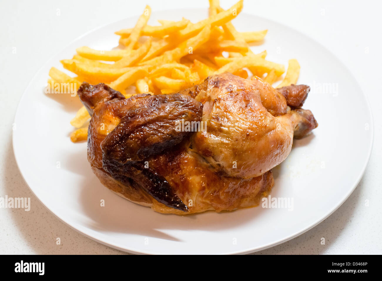 Chicken roasted with fries Stock Photo - Alamy