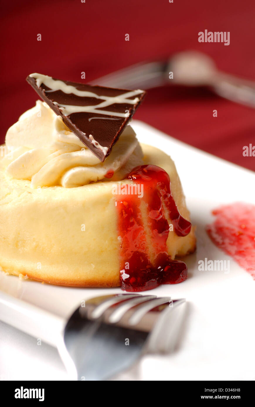 A rich vanilla mousse with whipped cream and raspberry sauce Stock ...