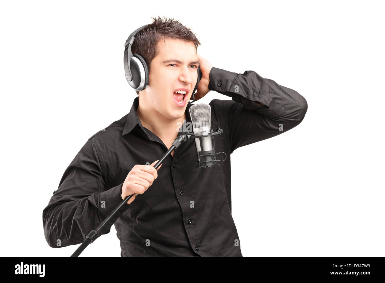 A male singer with headphones performing a song isolated on white ...