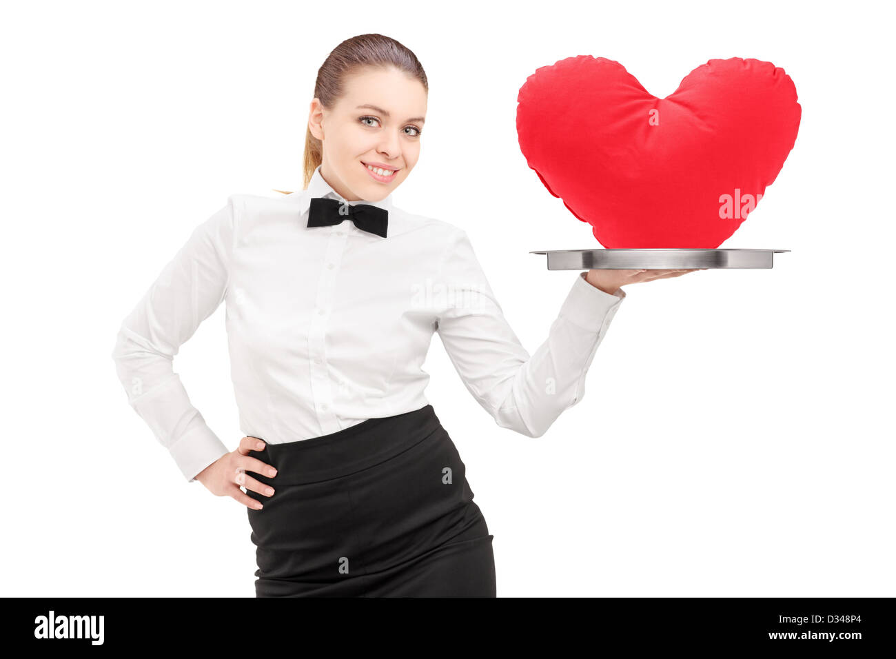 A waitress with bow tie holding a tray with red heart on it tray ...