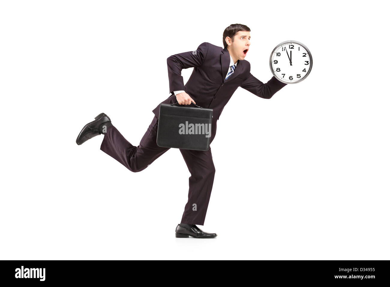 Full length portrait of a busy businessman running with wall clock and ...