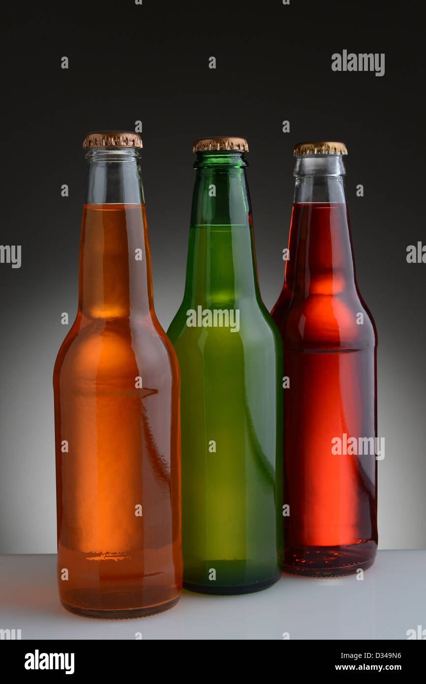Three Soda Bottles on a light to dark gray background Stock Photo - Alamy