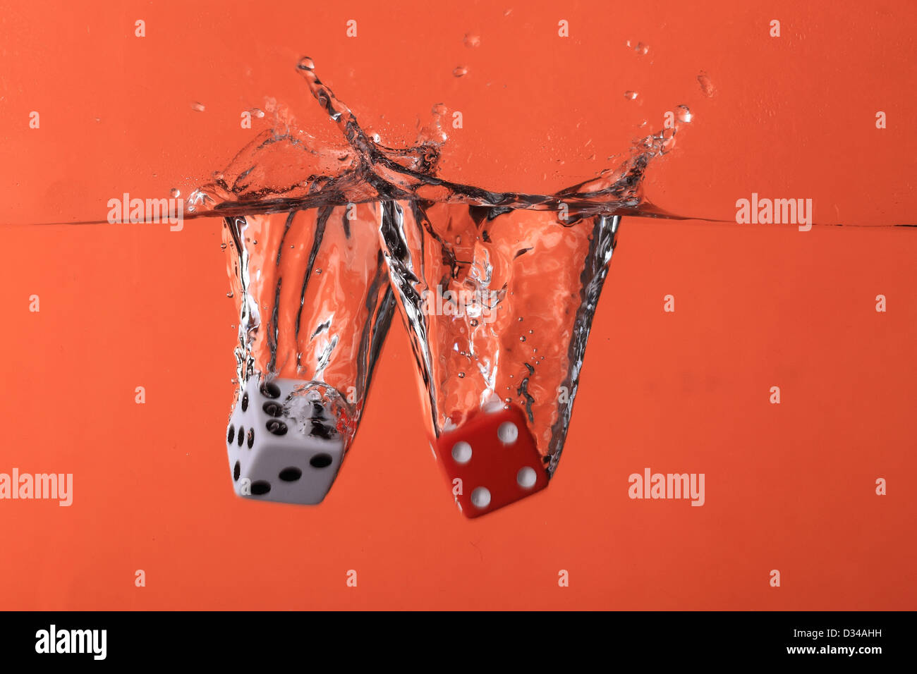 pair of dice dropping into water with the motion stopped for effect ...