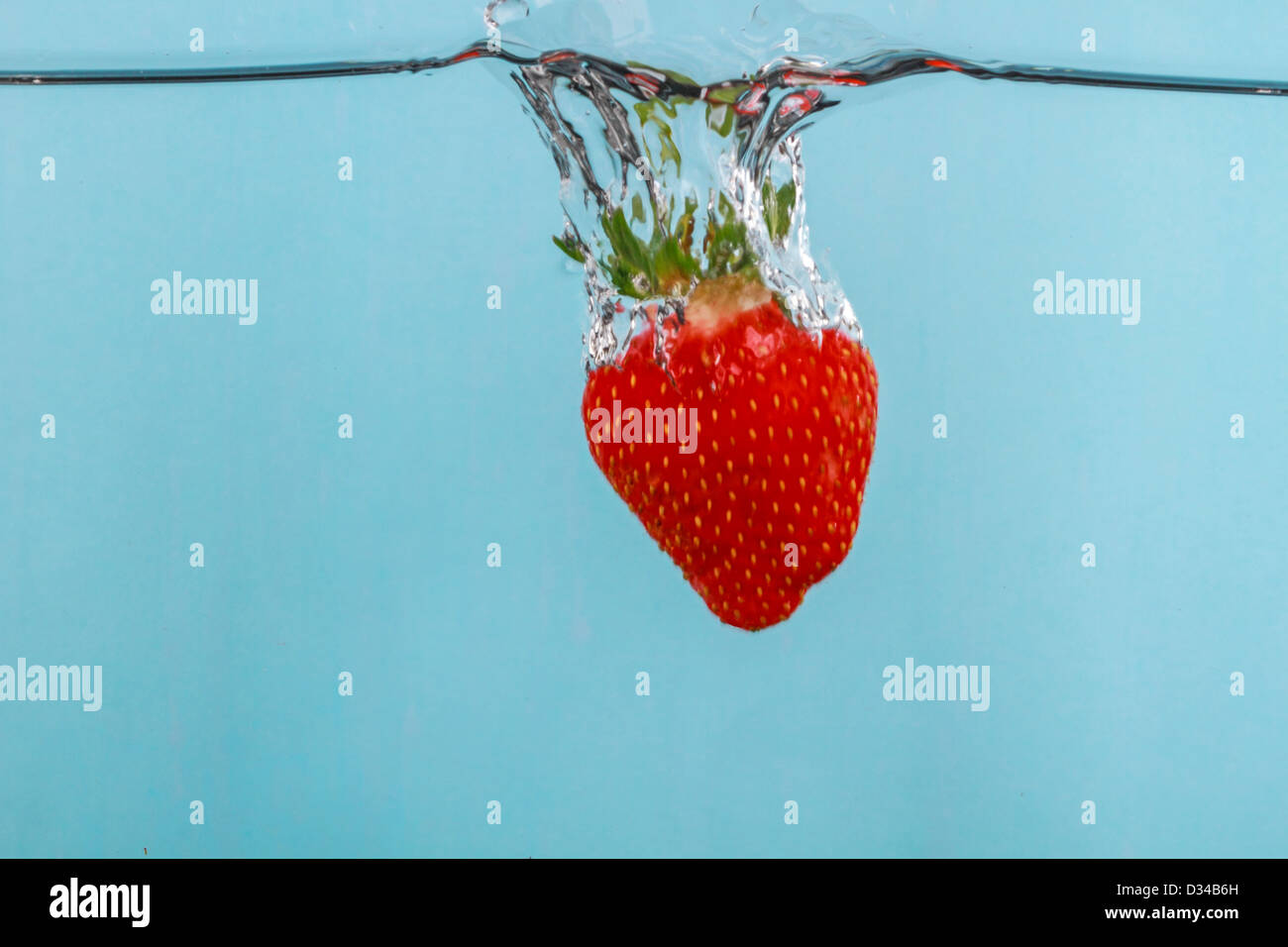 Strawberry falling into water with stop motion photography to capture ...