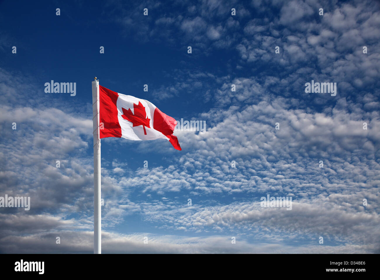 canadian flag against blue sky Stock Photo - Alamy